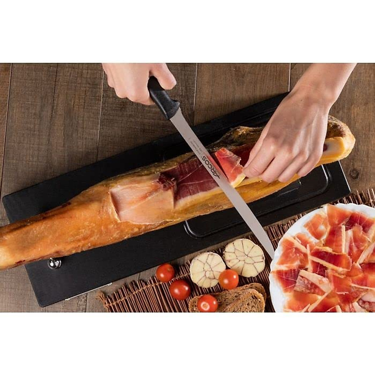 ARCOS Slicing Knife / Ham Knife 10 Inch Nitrum Stainless Steel and 240 mm blade. Ergonomic Polyoxymethylene POM Handle. Series Menorca. Handle made of lightbluish polypropylene. Color Black.
