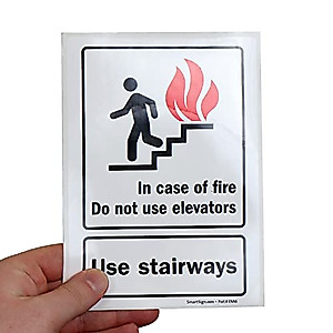 SmartSign (Pack of 4) 7 x 5 inch “in Case of Fire Do Not Use Elevators, Use Stairways” Sticker Labels with Symbol, 5 mil Laminated Polyester with SuperStick Adhesive, Red, Black and White