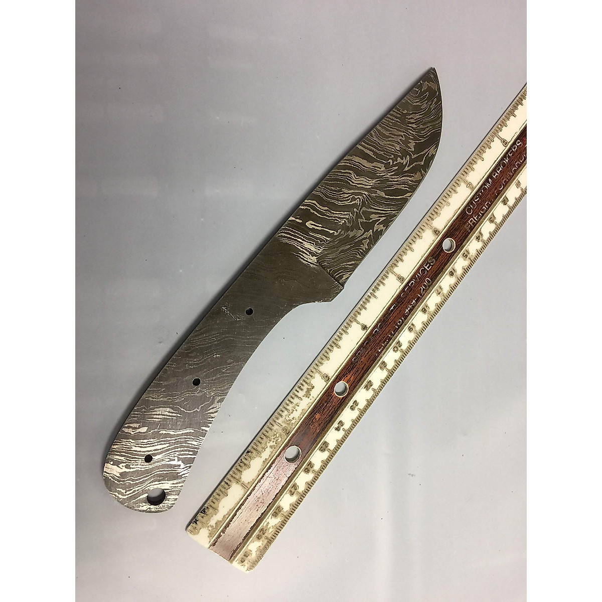 8.5 inches long hand forged Twist pattern Damascus steel trailing point blank blade skinning knife with 3 Pin hole & an inserting hole space 4 inches cutting edge