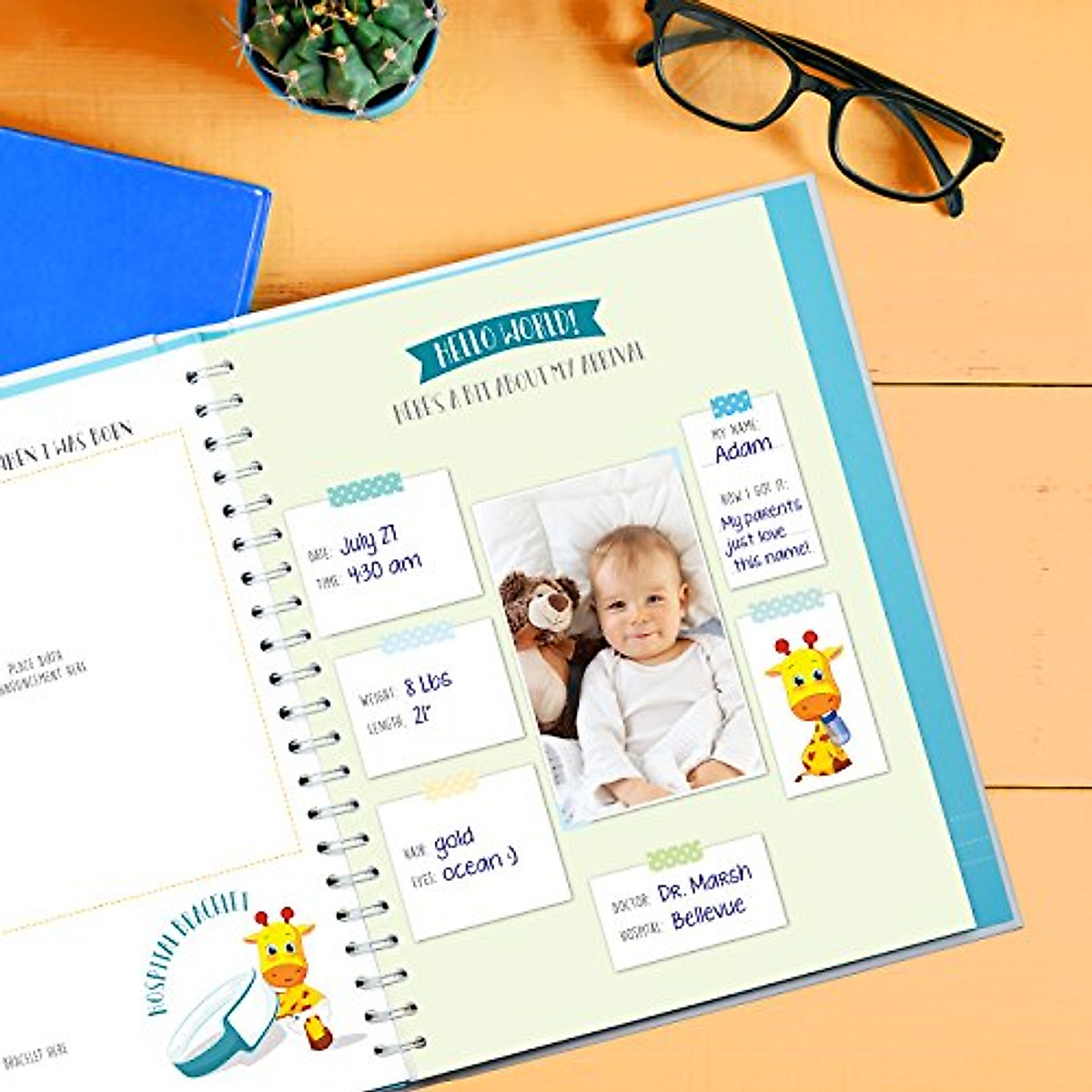 KiddosArt Baby Memory Book. Record Memories and Milestones of The First 5 Years On 72 Beautifully Drawn Pages Starring Lilly The Giraffe Blue. 12 Monthly Stickers Included.