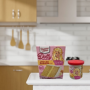 Dolly Parton Cake Mix Bundle with Buttercream Frosting - Features (2) boxes of southern banana cake mix (2) containers of buttercream frosting and (1) Make Every Day a Friday Kitchen Clip