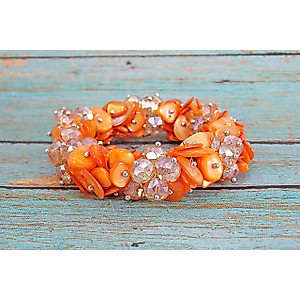 Calisa Designs Woman's orange shell and glass beaded stretch bracelet with silver beads, Designed with clusters of orange shell and orange facet cut glass beads.