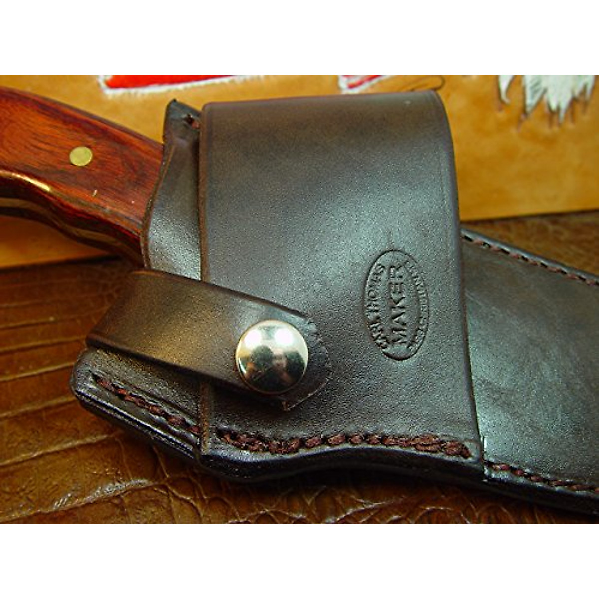 Custom-made Cross Draw Knife Sheath for the Buck Kalinga 401 Knife. The Sheath Is Made Out of 10 Ounce Water Buffalo Hide Leather. The 10 oz. Leather is Dyed Dark Brown. The Sheath Also Has a Strap for Extra Security of Your Knife From Falling Out. The Sh