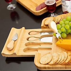Roots To Table Bamboo Cheese and Charcuterie Board Set. This Cheese Board Set is a Perfect Cheese Platter and Charcuterie Board Gift Set Idea. Slide-Out Drawer Contains Stainless Steel Knife Set.