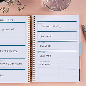 A5 Spiral - Bound Wellness Planner. 3 Months of Planning Pages. Daily Food, Movement, and Self-Care Trackers. Reflection and Celebration Pages. 6 Tabs. Sticker Sheet Included by Erin Condren.