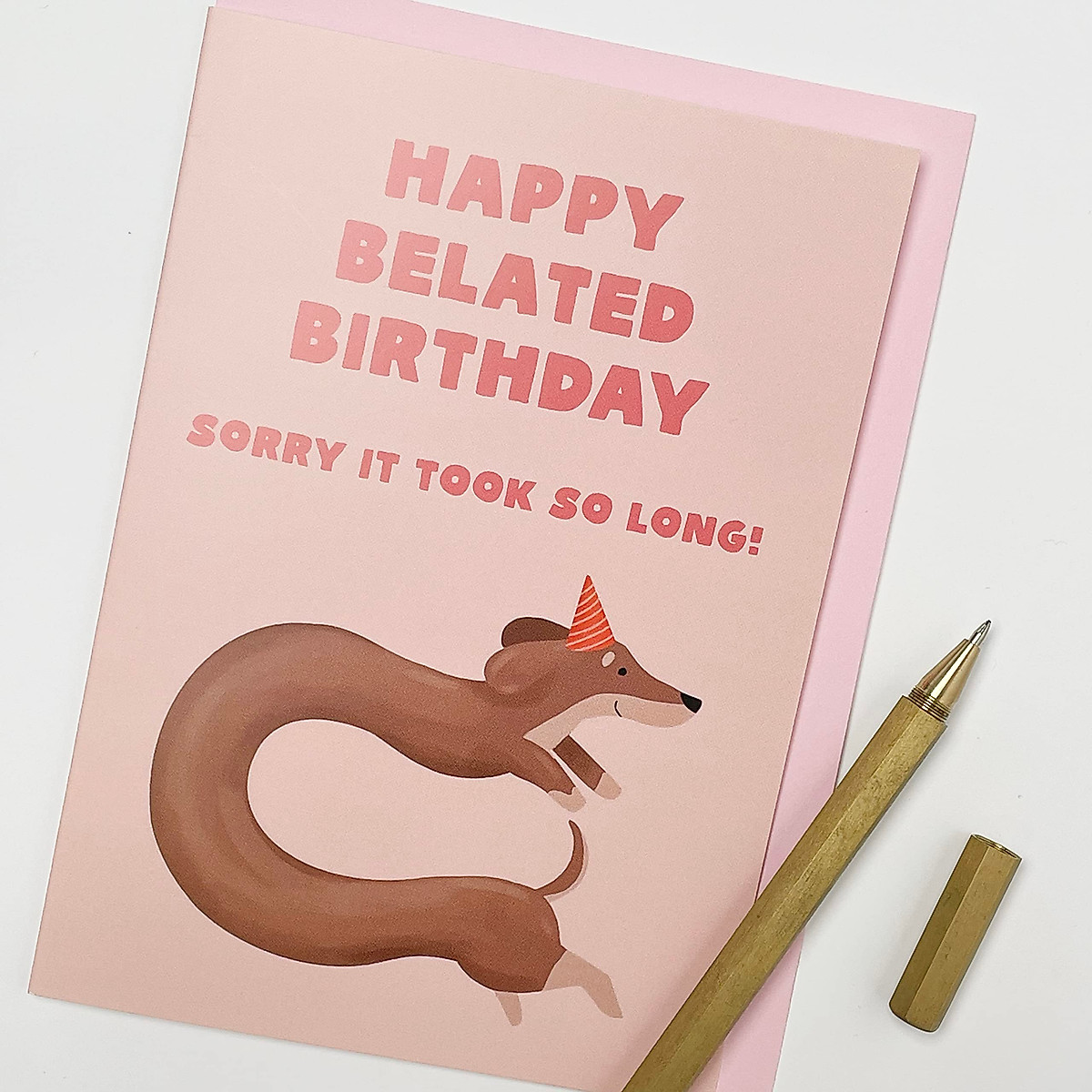 Old English Co. Sausage Dog Funny Belated Birthday Card for Him or Her - Sorry It's Late Birthday Card for Friend and Family - Cute Delayed Birthday Card Dachshund Dog | Blank Inside with Envelope