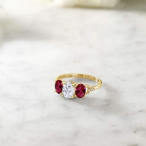 Gem Stone King 10K Yellow Gold Red Created Ruby White Moissanite and Diamond Accent 3 Stone Engagement Ring For Women (1.92 Cttw, Available In Size 5, 6, 7, 8, 9)
