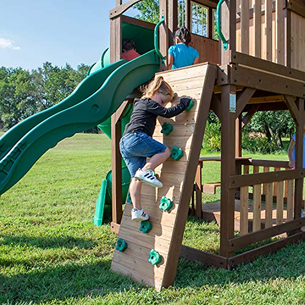 Backyard Discovery Skyfort All Cedar Swing Set, Elevated Covered Wood Roof Clubhouse with Bay Windows, 2 Belt Swings, Web Swing, 10ft Wave Slide, 5 ft Tube Slide, Covered Picnic Table, 5 ft Rock Wall