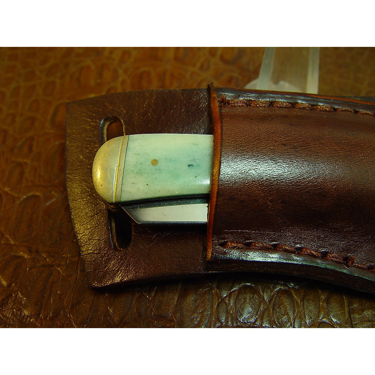 Custom Right-hand Cross Draw Trapper Style Folding Knife Sheath. Made Out of 10 Ounce Buffalo Hide Leather. Dyed Light Brown Sheath Only Knife Not Included.