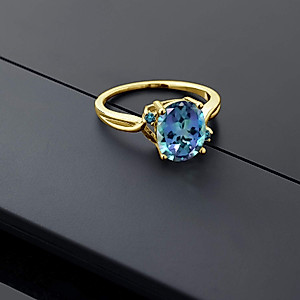 Gem Stone King 18K Yellow Gold Plated Silver Millennium Blue Mystic Topaz and Blue Diamond 3 Stone Ring For Women (3.03 Cttw, Oval 10X8MM, Gemstone Birthstone, Available In Size 5, 6, 7, 8, 9)