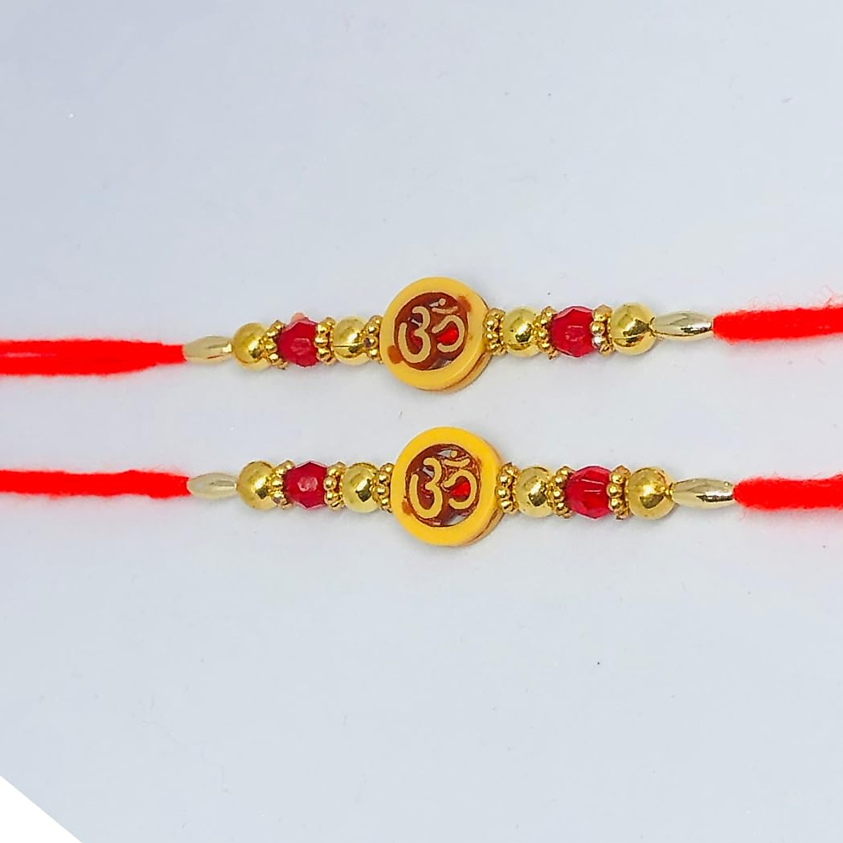 ZYRENA Rakhi for Brother Bhaiya Bhabhi, Gift Rakhi for Family, Raksha Bandhan Festival Rakhi for Bhaiya and Bhabhi, Round Om Pendant with Red-Golden Beads and Rings Rakhi Thread, Pack of 2