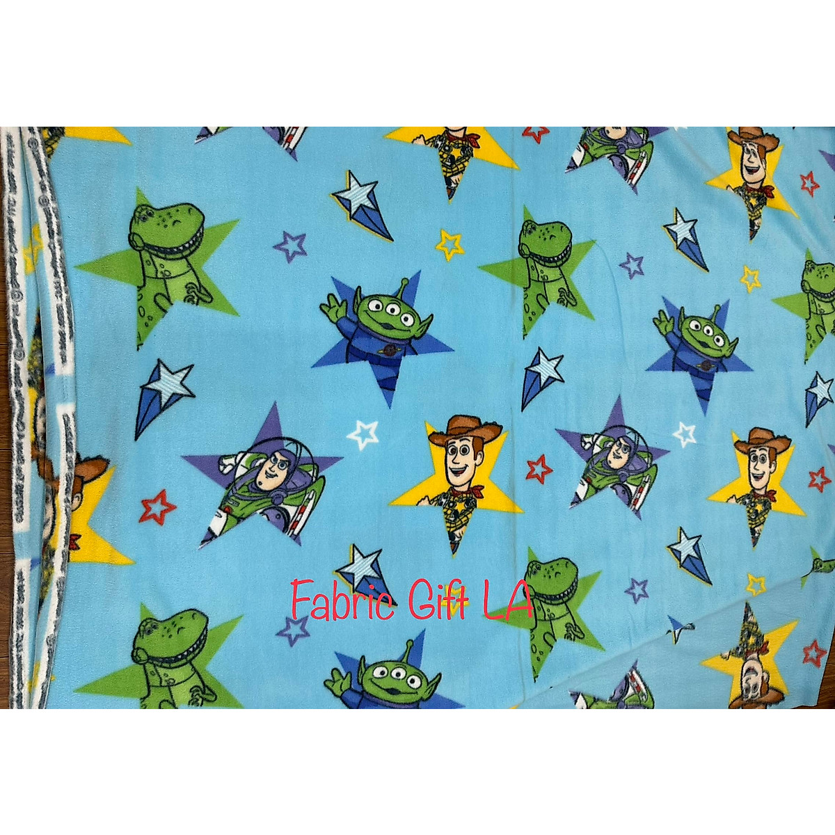 Disney Toy Story 4 Character Stars on Sky Blue Fleece from Springs Creative Buzz Light Year and Woody Fabric by The Yard