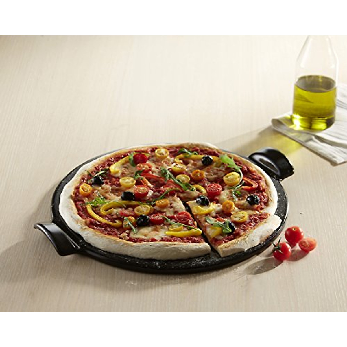 Emile Henry Made in France Flame Top Pizza Stone, Black. Perfect for Pizzas or Breads. In the Oven, On Top of the BBQ. Safe up to 750 degrees F. 100% Natural Clay, Glazed Surface. Easy to Clean.