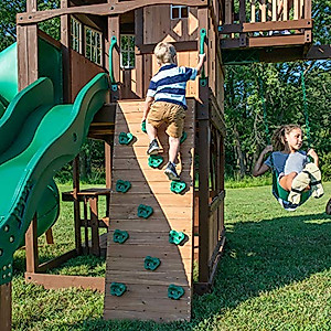 Backyard Discovery Skyfort All Cedar Swing Set, Elevated Covered Wood Roof Clubhouse with Bay Windows, 2 Belt Swings, Web Swing, 10ft Wave Slide, 5 ft Tube Slide, Covered Picnic Table, 5 ft Rock Wall
