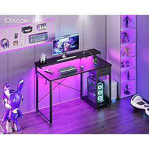 AODK Gaming Desk with LED Lights & Power Outlet, 40 Inch Computer Desk with Drawer, Reversible Desk with Adjustable Monitor Shelf & Headphone Hook for Home Office, Black