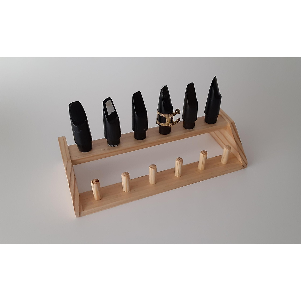 Saxophone mouthpiece wooden stand holder rack for 12 mouthpieces.