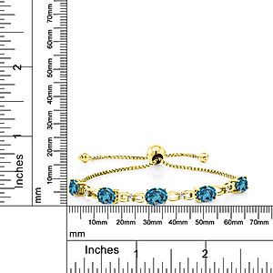 Gem Stone King 18K Yellow Gold Plated Silver London Blue Topaz and White Lab Grown Diamond Tennis Bracelet For Women (5.02 Cttw, Gemstone Birthstone, Oval 7x5MM, Fully Adjustable Up to 9 Inch)